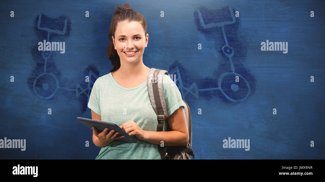 Happy student using tablet against blue background Stock Photo - Alamy