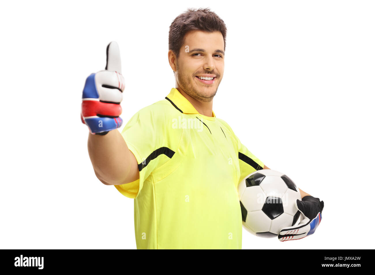 Goalkeeper holding a football and making a thumb up sign isolated on ...