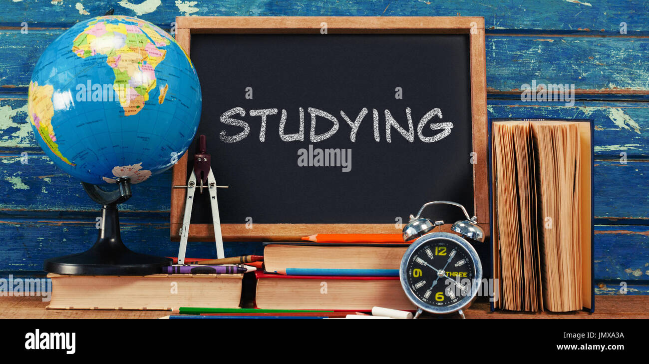 Studying text on white background against empty blackboard with school ...