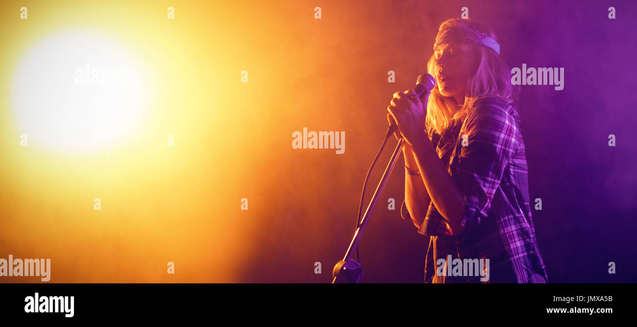 Female singer performing at concert in nightclub Stock Photo - Alamy