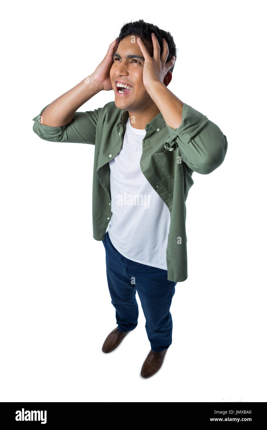 Happy man with hands on head standing on white background Stock Photo ...