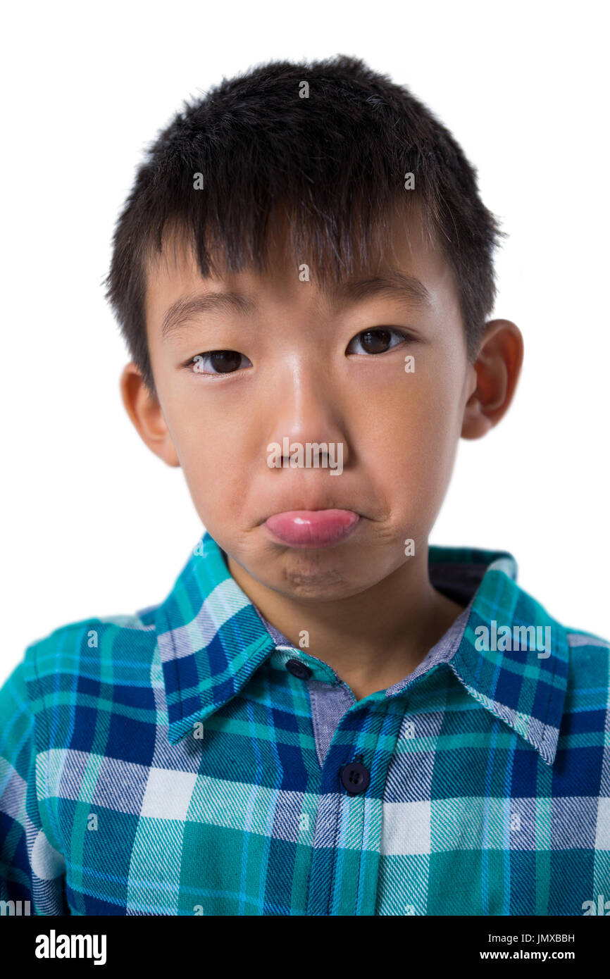Close-up of cute boy making faces against white background Stock Photo ...
