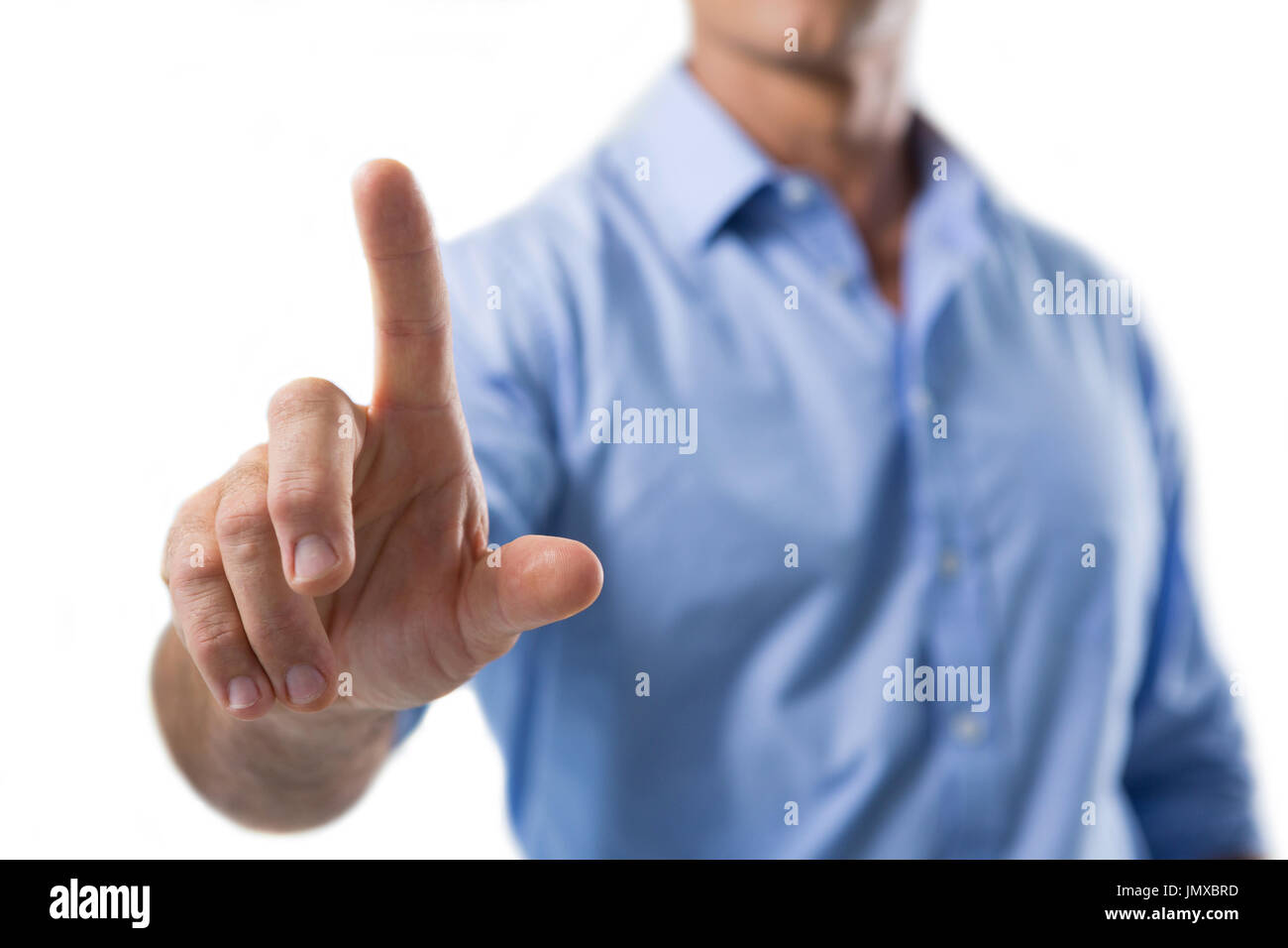 Mid section of male executive pressing an invisible virtual screen ...