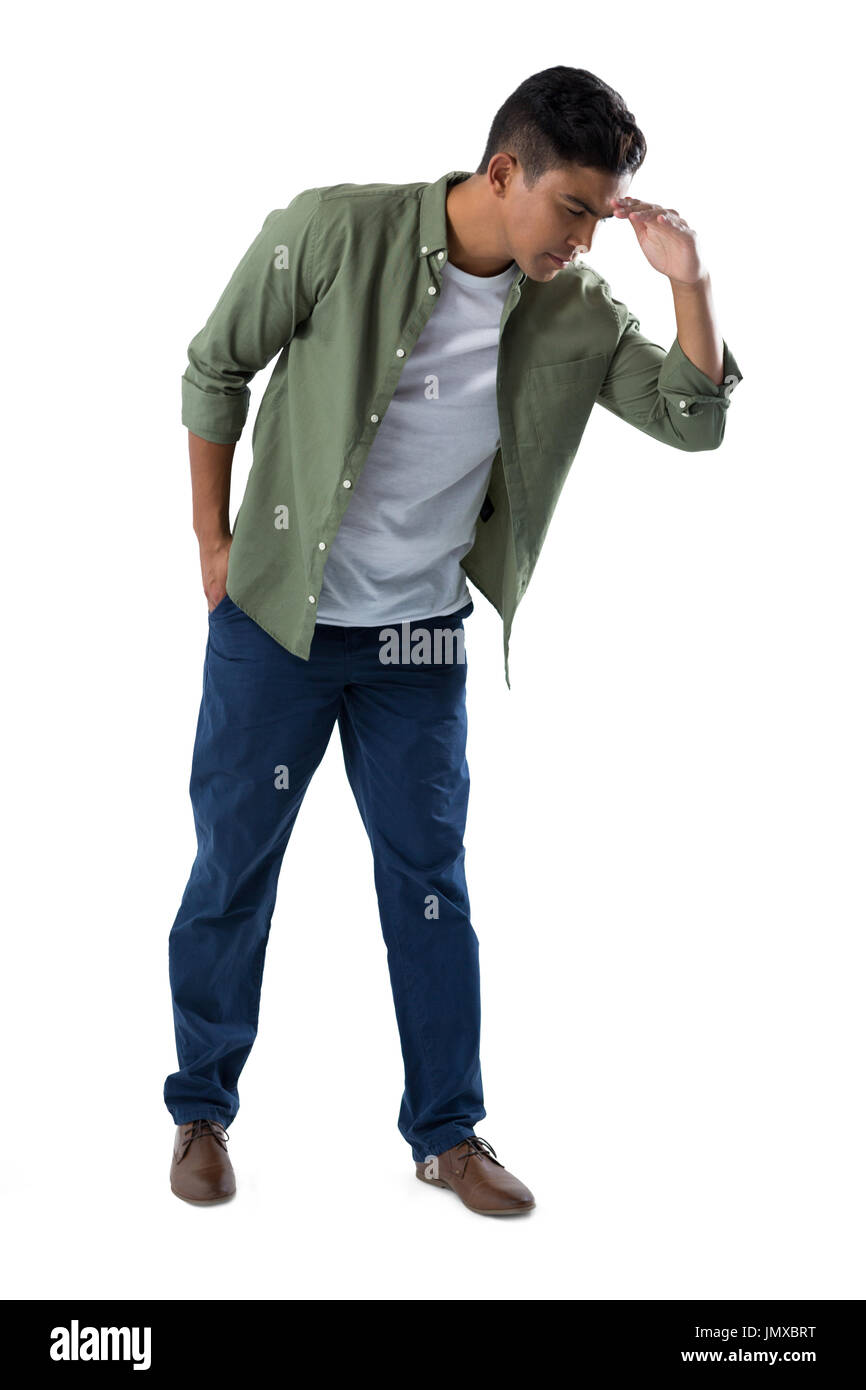 Handsome man shielding eyes on white background Stock Photo - Alamy