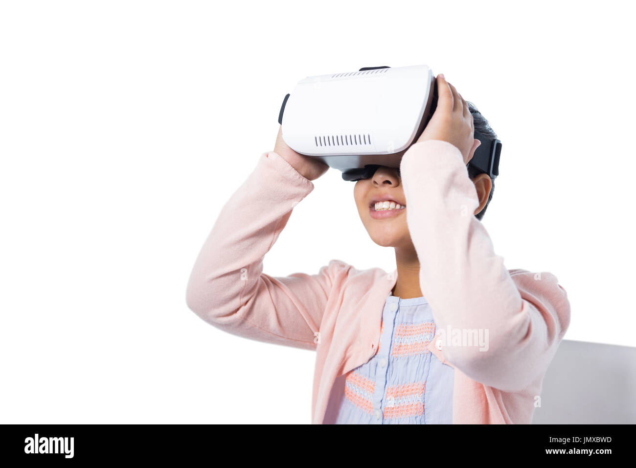 Girl using virtual reality headset against white background Stock Photo ...