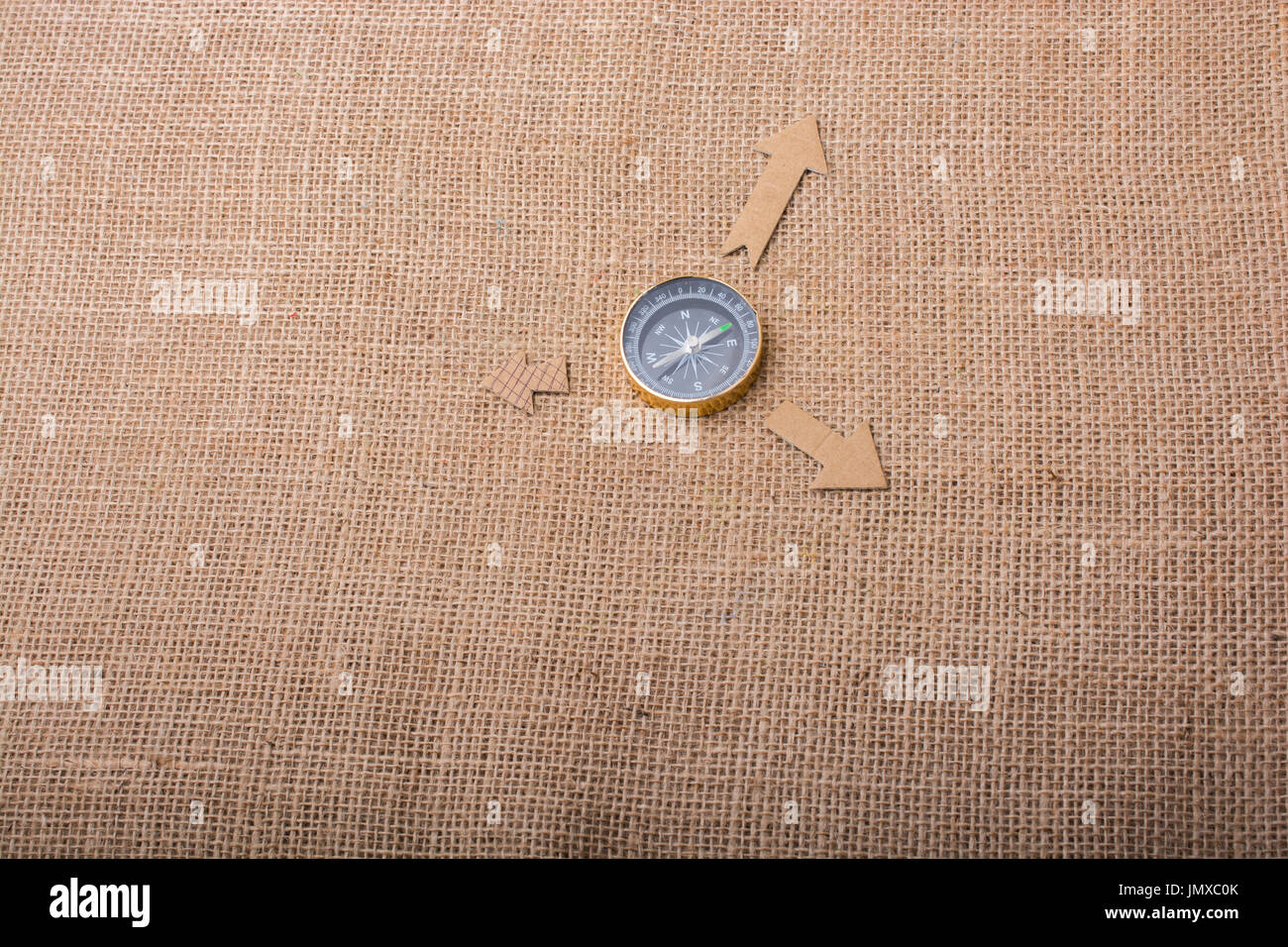 Compass and paper arrow on a canvas background Stock Photo - Alamy