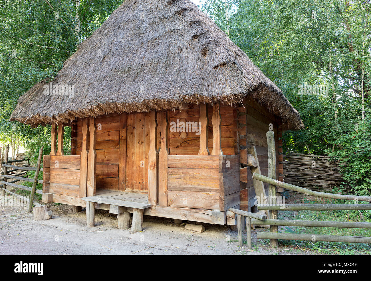 Old traditional Ukrainian rural barn with a thatched roof and a wooden ...