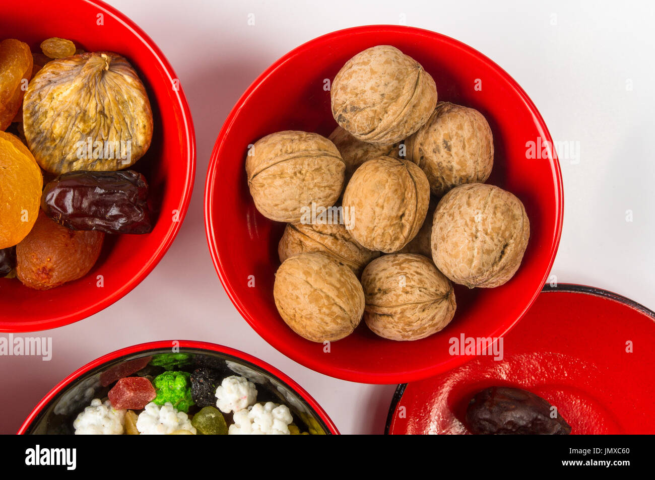 various dried fruits, mixed nuts and walnuts on the white background ...