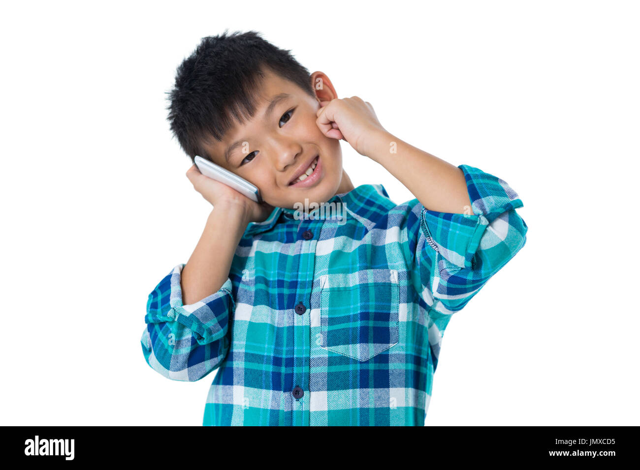 Portrait of boy talking on mobile phone against white background Stock ...