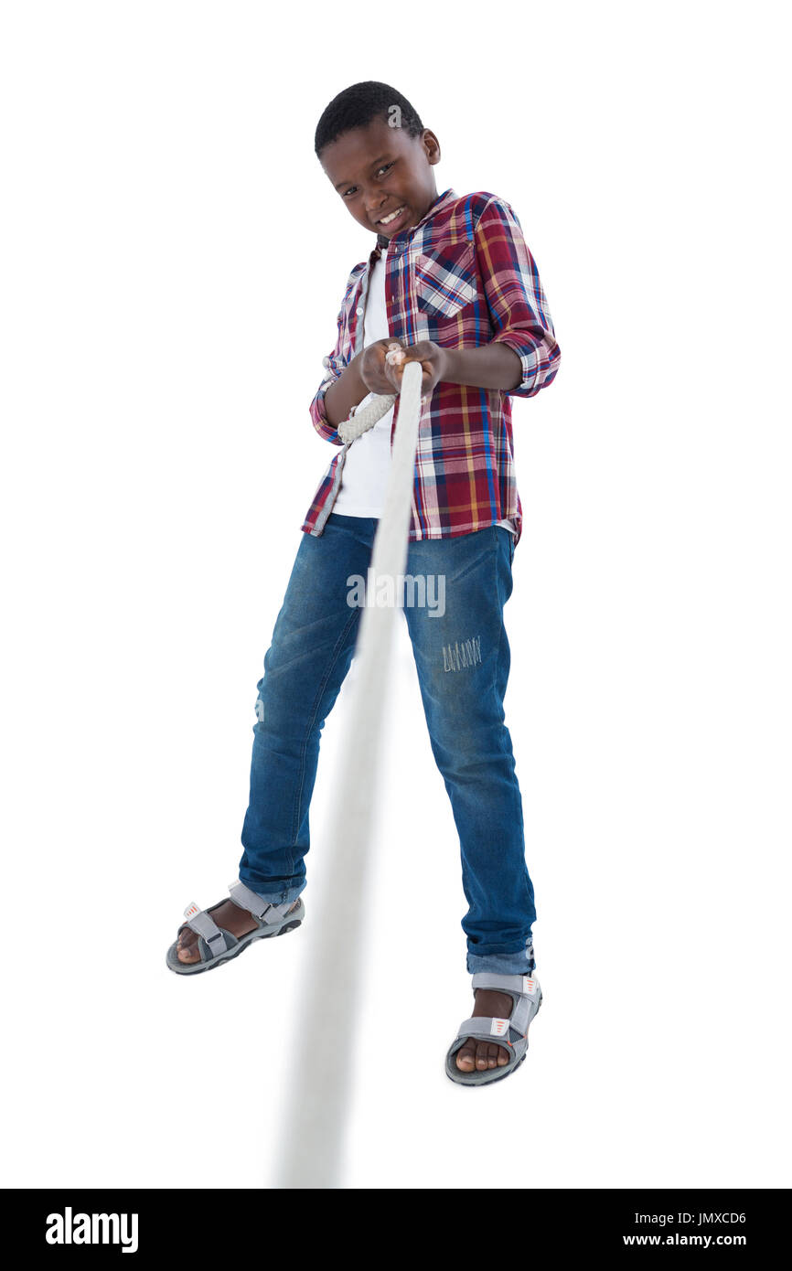 Boy pulling the rope against white background Stock Photo - Alamy