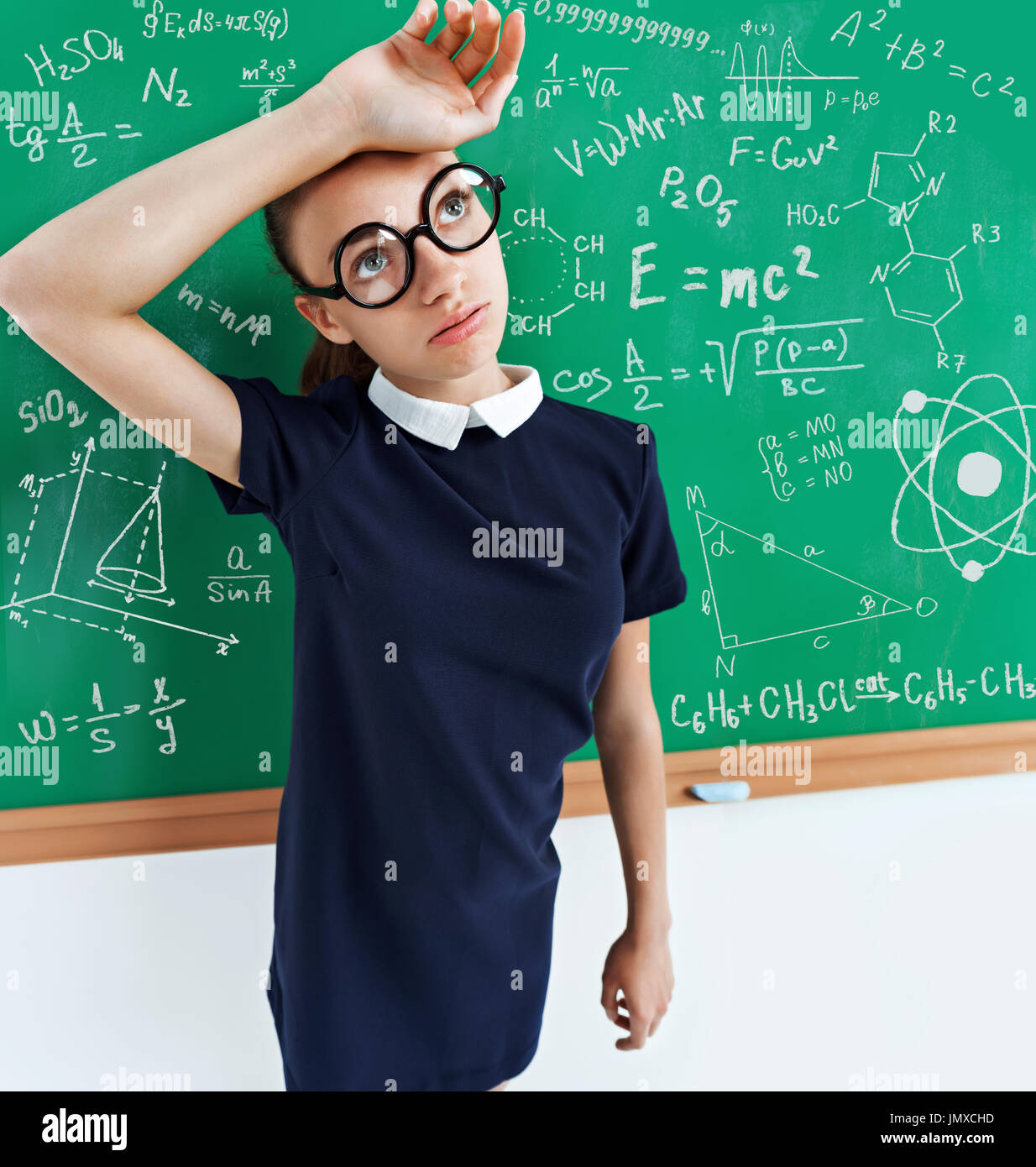 Tired student solved all the examples on the blackboard. Photo of a ...