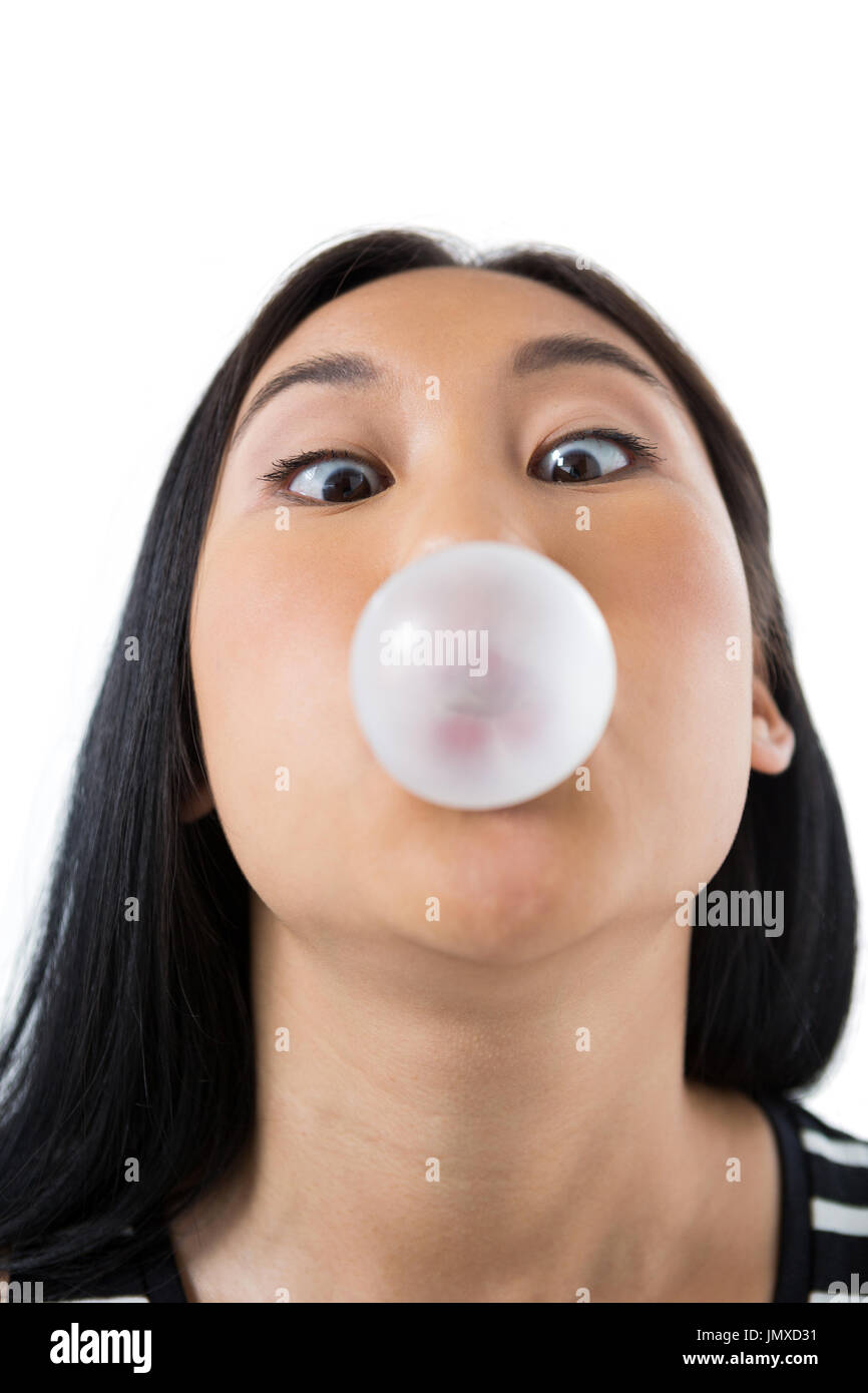 Woman blowing bubble gum against white background Stock Photo - Alamy