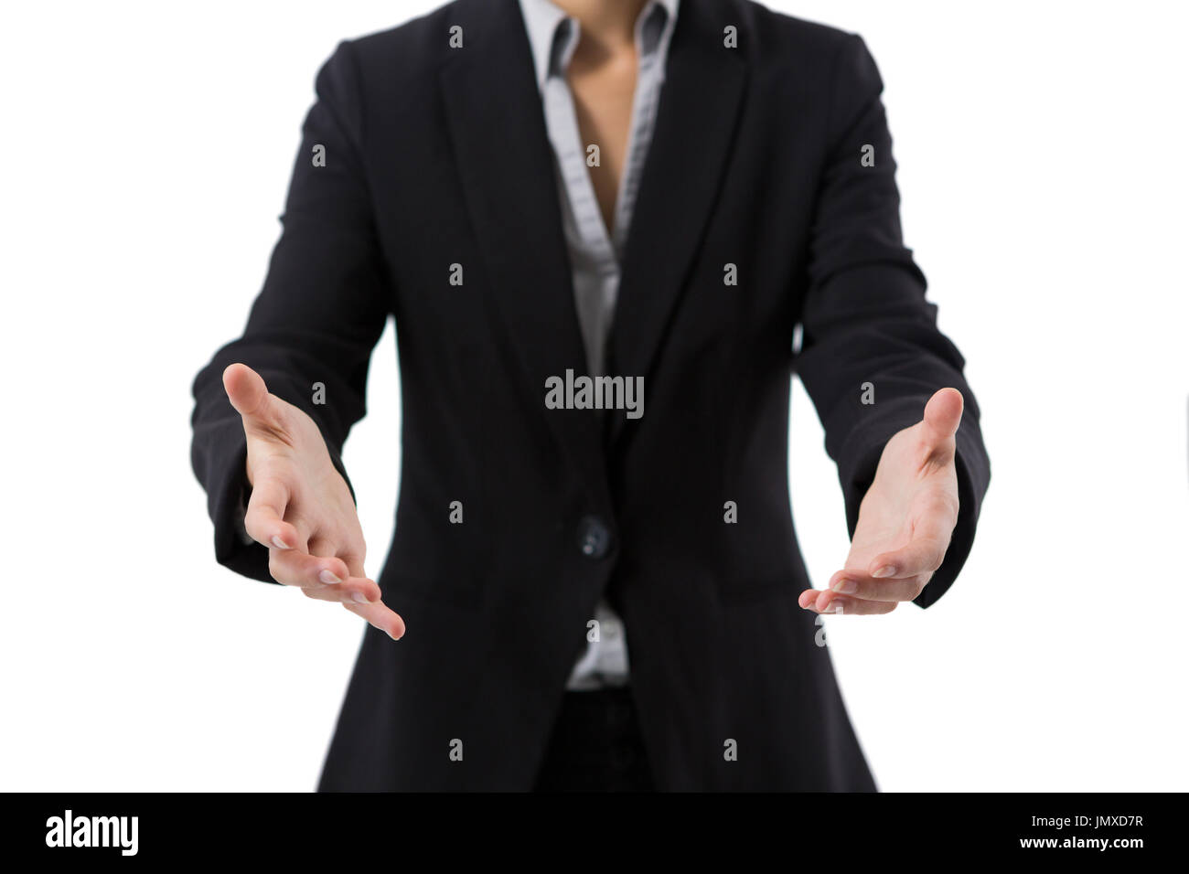 Mid section of businesswoman holding invisible object against white ...