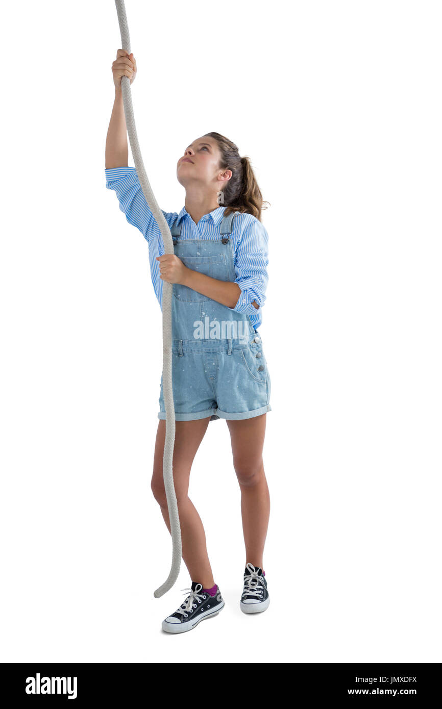 Teenage girl climbing the rope on white background Stock Photo - Alamy