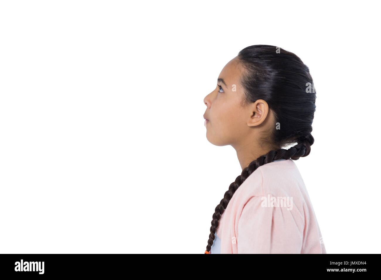 Side view of thoughtful girl standing against white background Stock ...