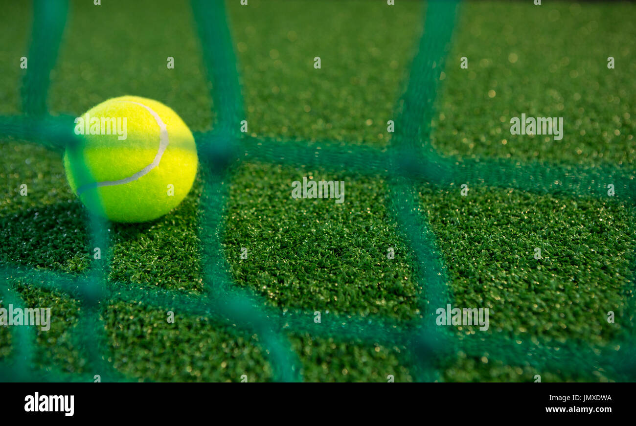 Close up of tennis ball seen through net on court Stock Photo - Alamy