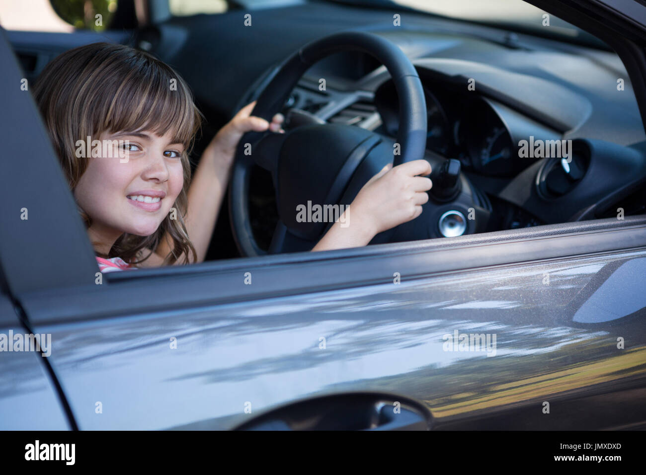 Portrait of happy teenage girl driving a car Stock Photo - Alamy