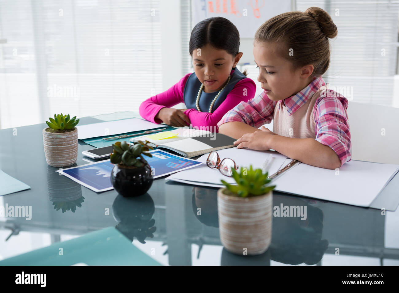 Kids as business executive reading book in office Stock Photo - Alamy