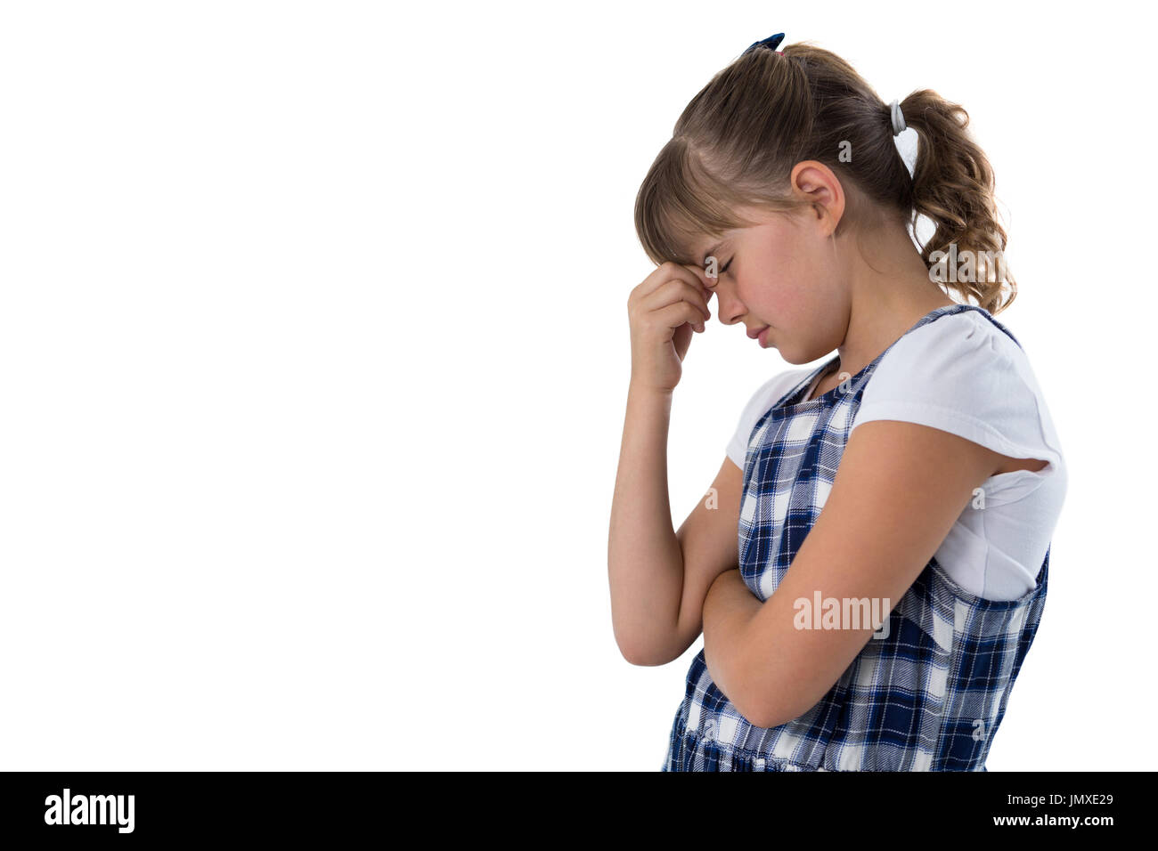 Close-up of sad girl standing against white background Stock Photo - Alamy