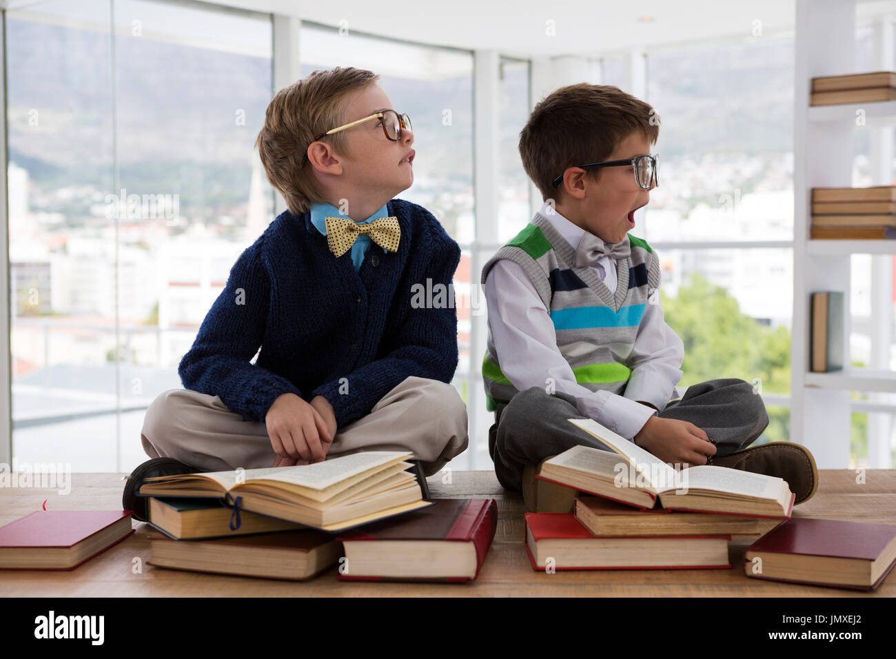 Kids as business executive sitting on a table at office Stock Photo - Alamy