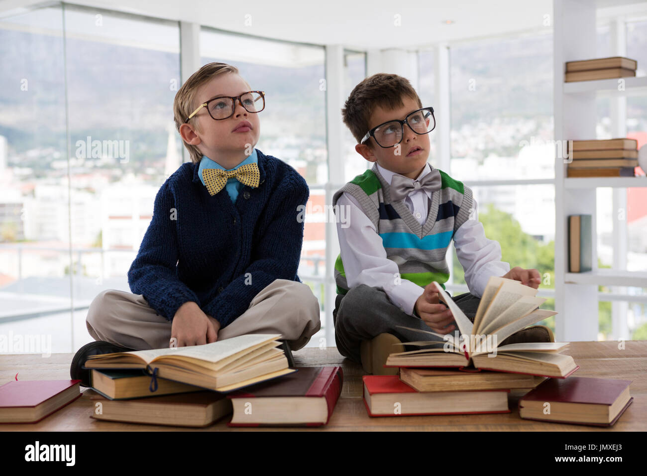 Kids as business executive sitting on a table at office Stock Photo - Alamy