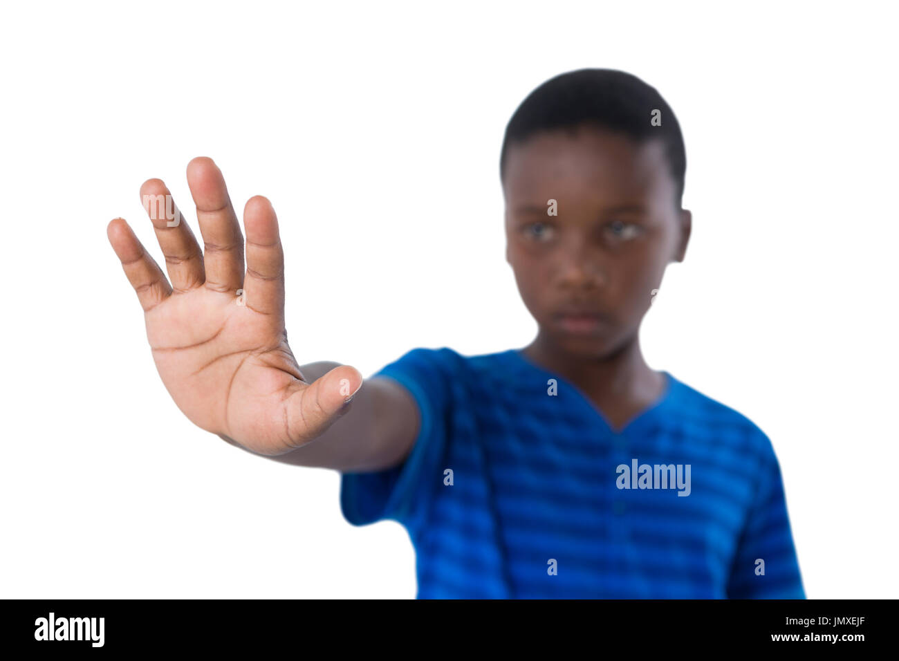 Boy showing stop sign against white background Stock Photo - Alamy
