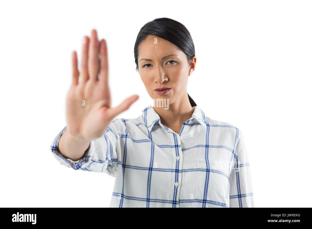 Portrait woman showing stop sign against white background Stock Photo ...