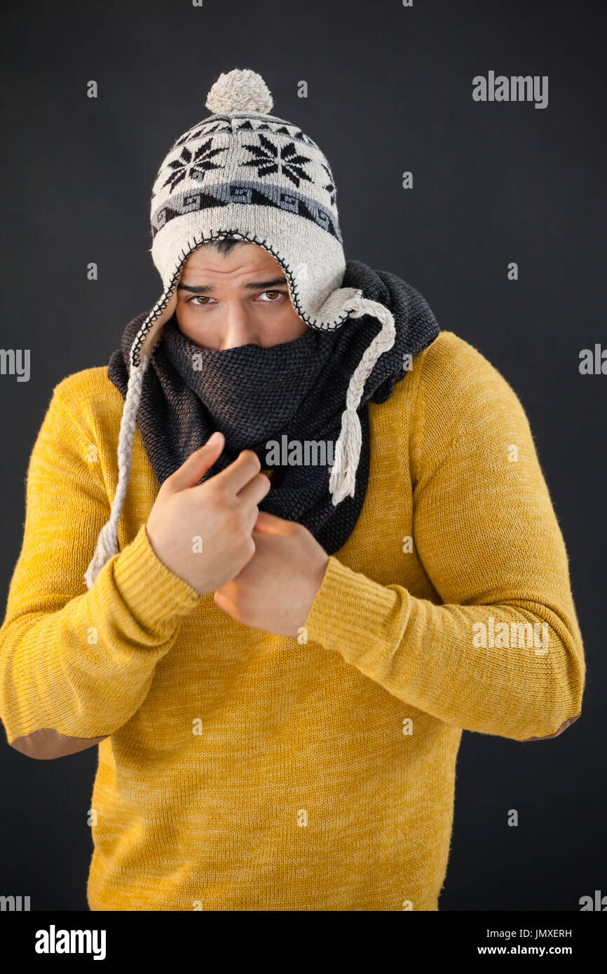 Portrait of man feeling cold against black background Stock Photo - Alamy