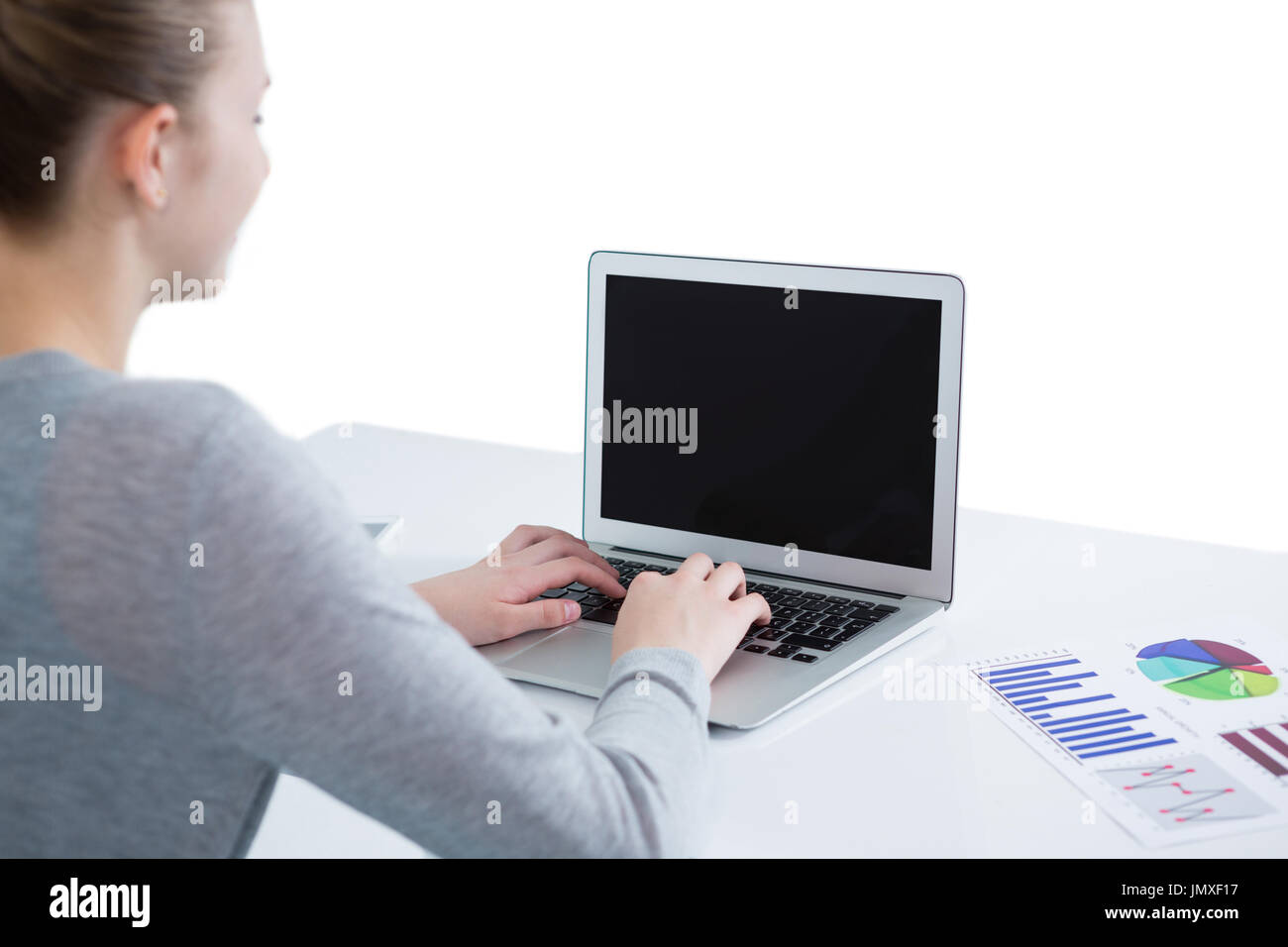 Rear view of teenage girl using laptop Stock Photo - Alamy