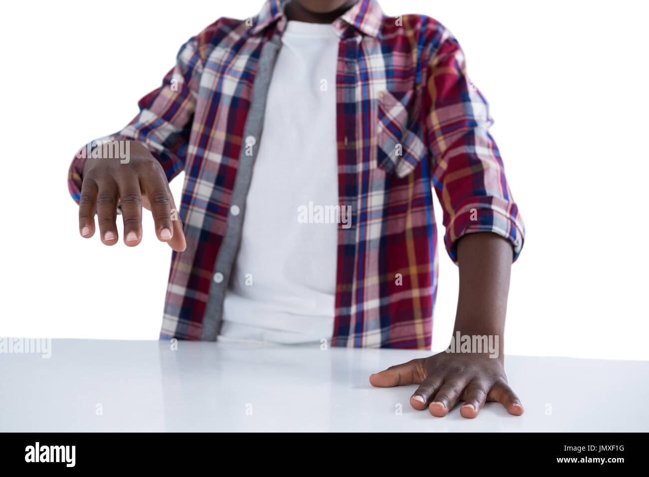 Mid-section of boy pretending to work on an invisible object against ...