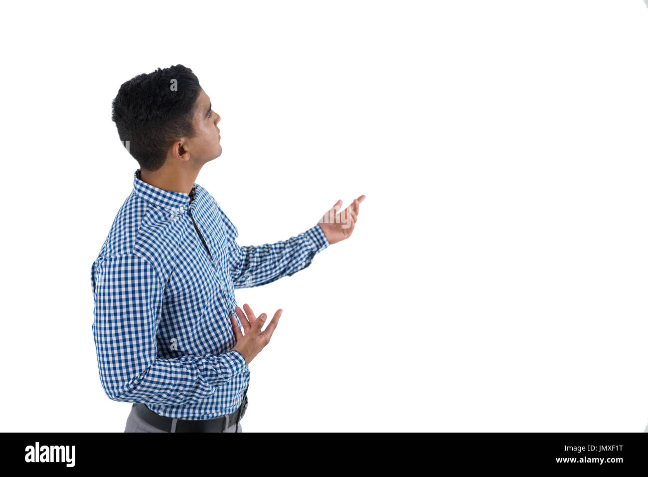 Attentive man gesturing against white background Stock Photo - Alamy