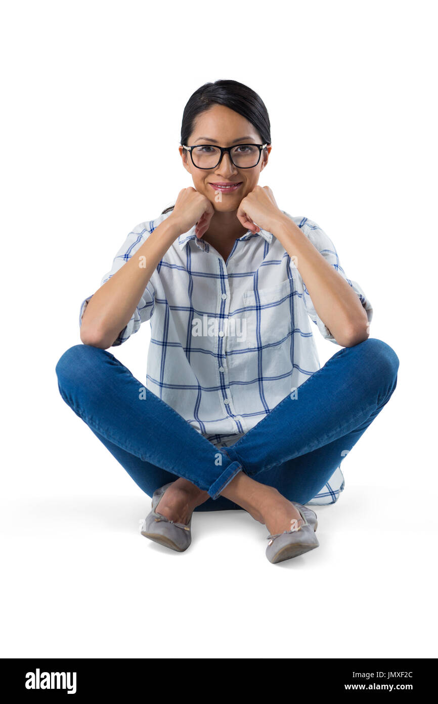 Portrait of woman relaxing against white background Stock Photo - Alamy