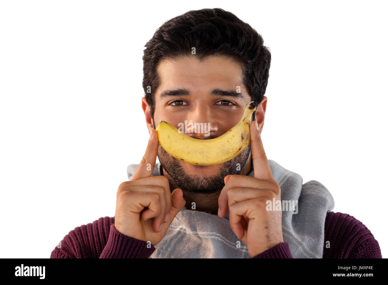Portrait of smiling man holding banana against white background Stock ...
