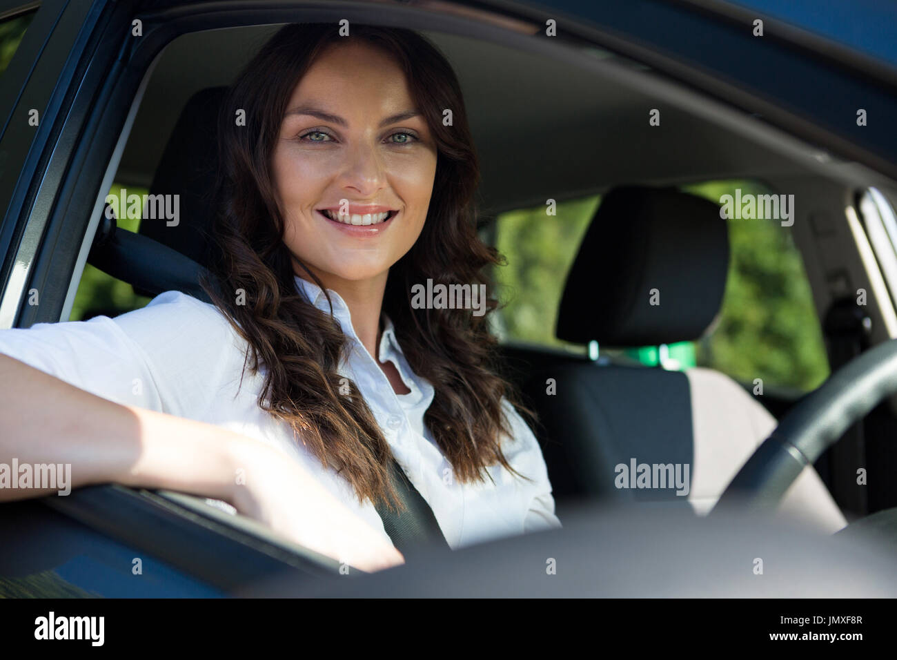 Portrait of beautiful woman driving a car Stock Photo - Alamy