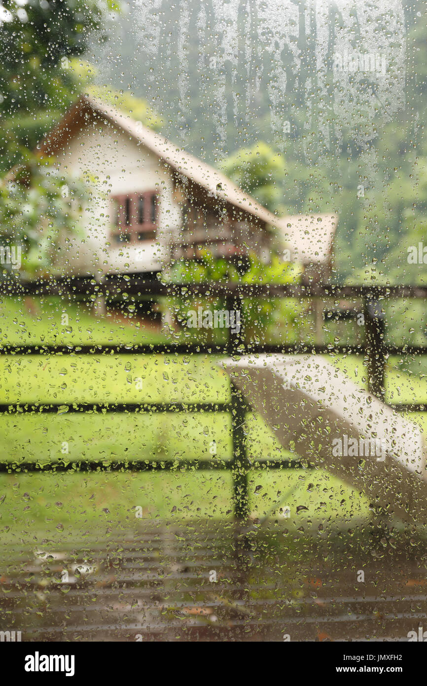 Raindrops and wooden house in background Stock Photo - Alamy