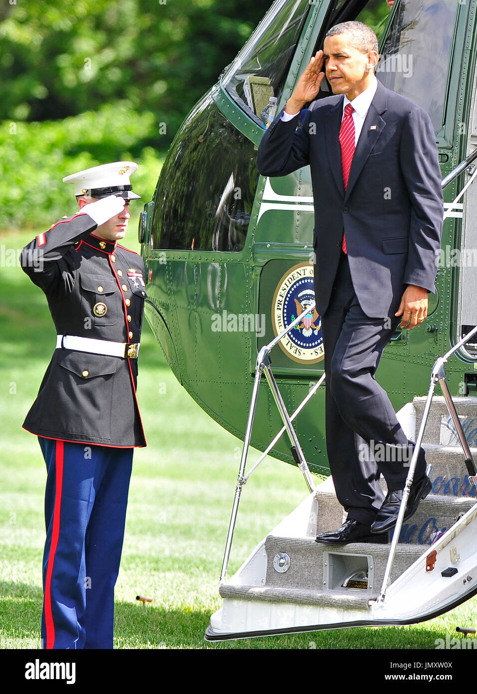 United States President Barack Obama salutes the Marine Guard as he ...