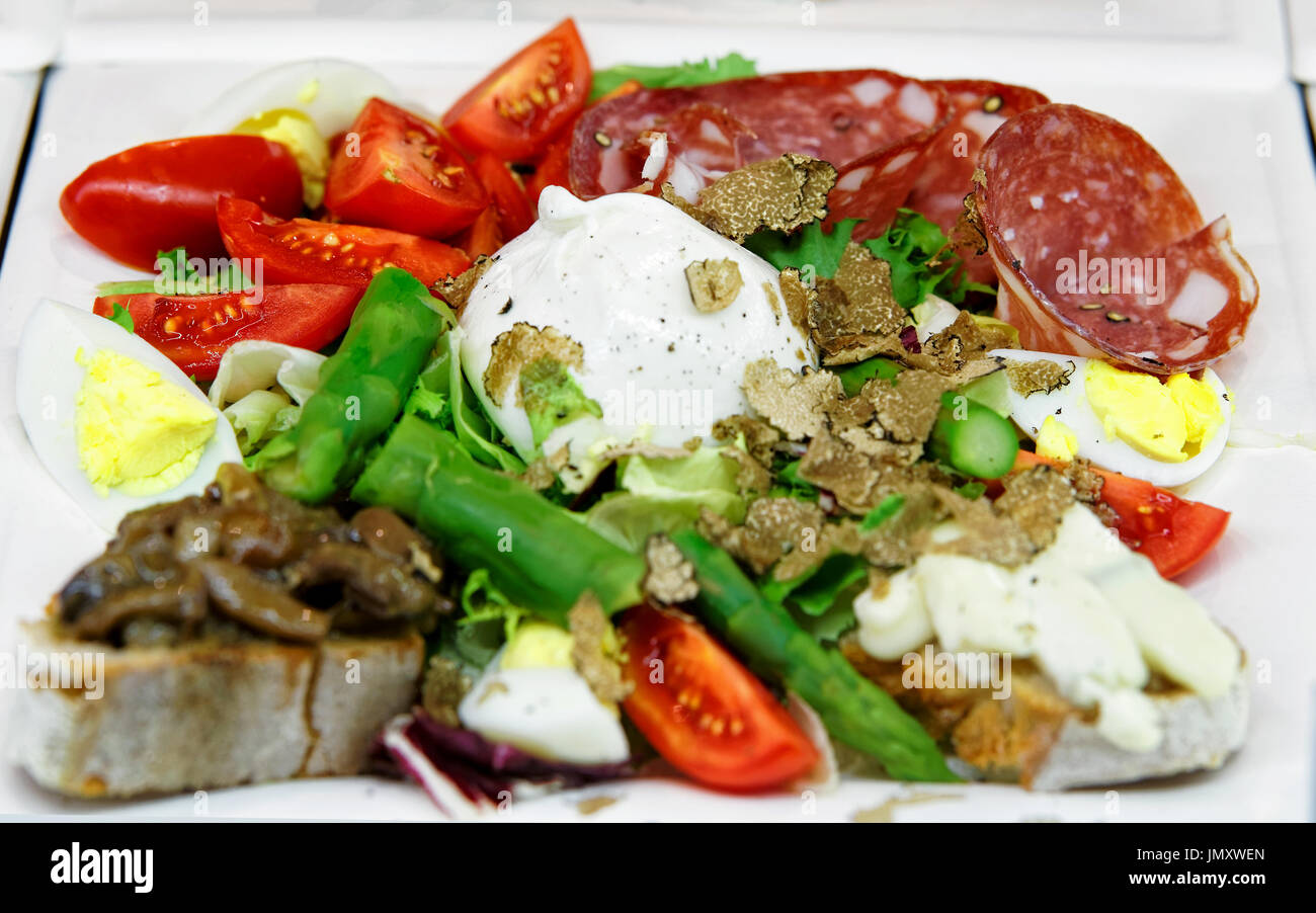 Traditional Italian platter with tomato, cheese, bread and truffle ...