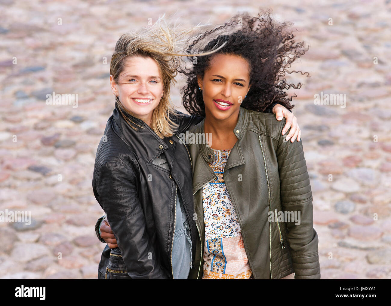 Happy caucasian and middle eastern female friends as diversity ...