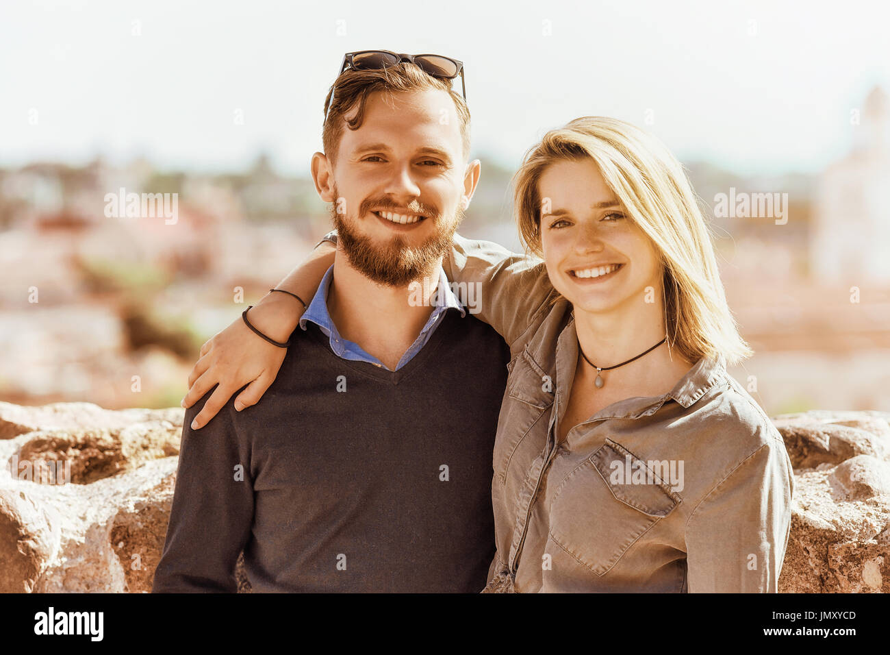 Happy young brother and sister hugging each other as friendship and ...