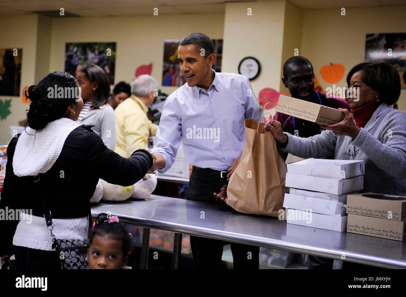 United States President Barack Obama packs and delivers bags of food to ...
