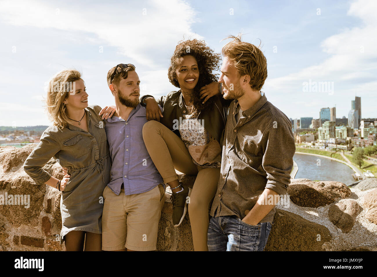 Smiling middle eastern young girl with her european friends as ...