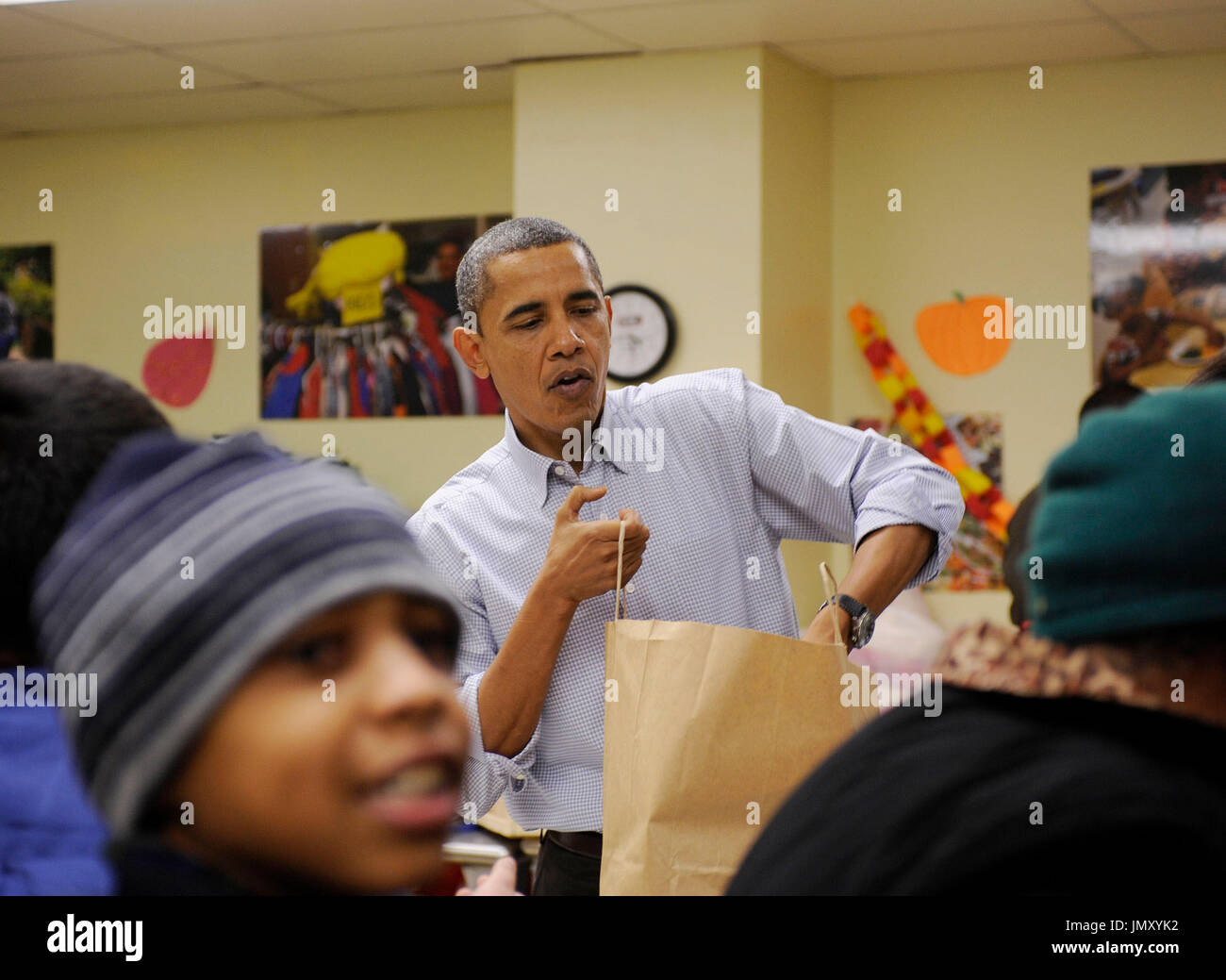 United States President Barack Obama packs and gives bags of food to ...
