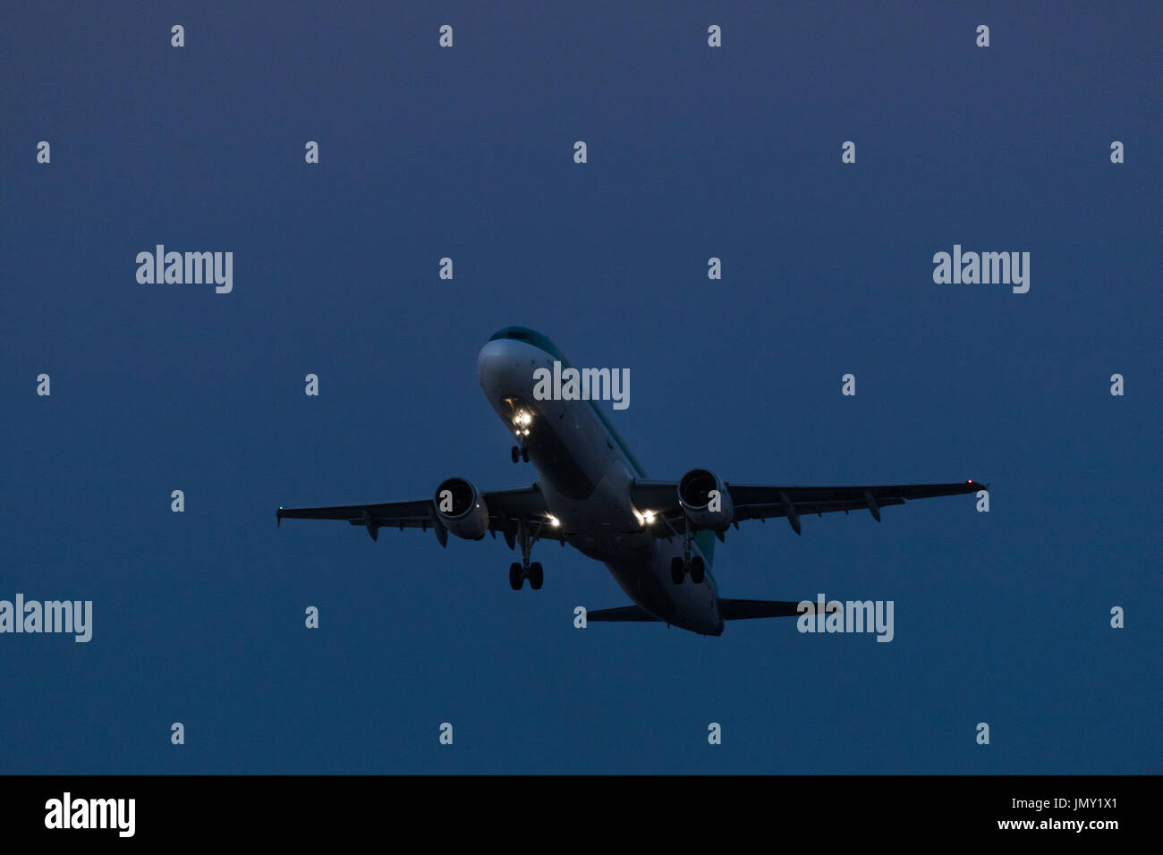 Passenger plane fly up over take-off runway from airport at sunset Stock Photo - Alamy