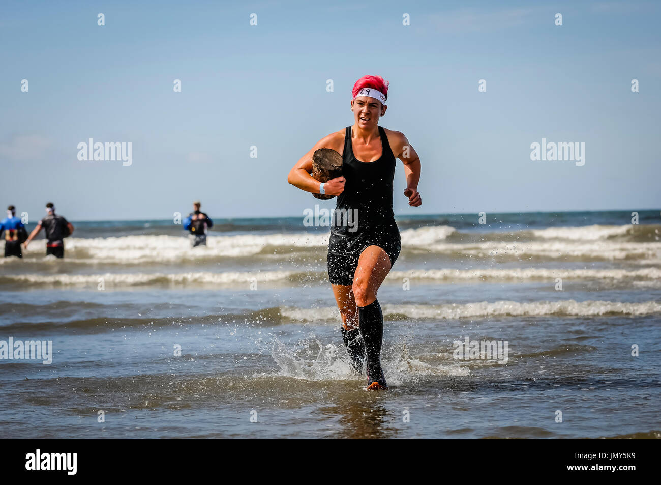 Log carry into the sea, unusual obstacle on obstacle course race Stock ...