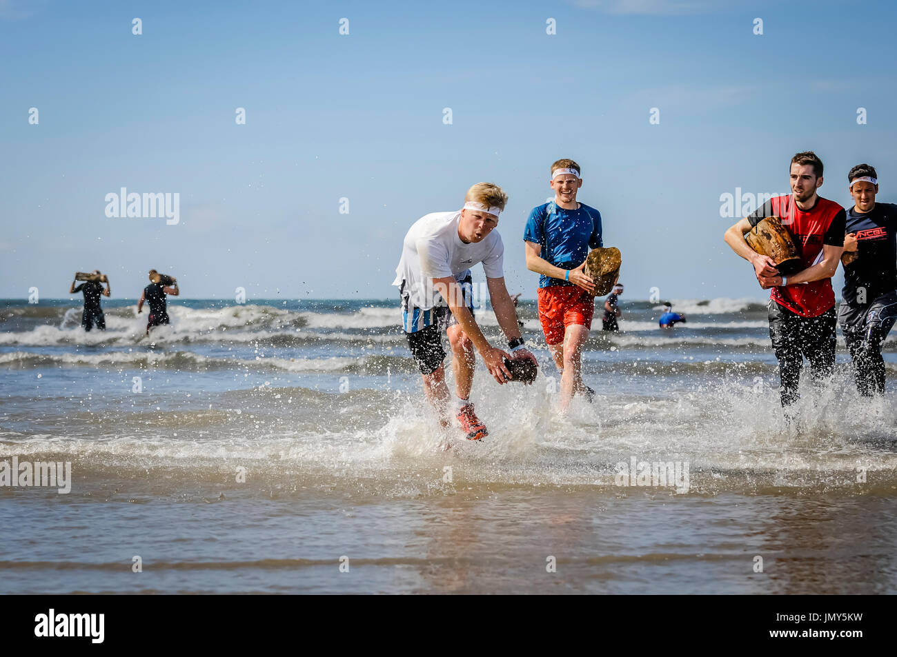 Log carry into the sea, unusual obstacle on obstacle course race Stock ...