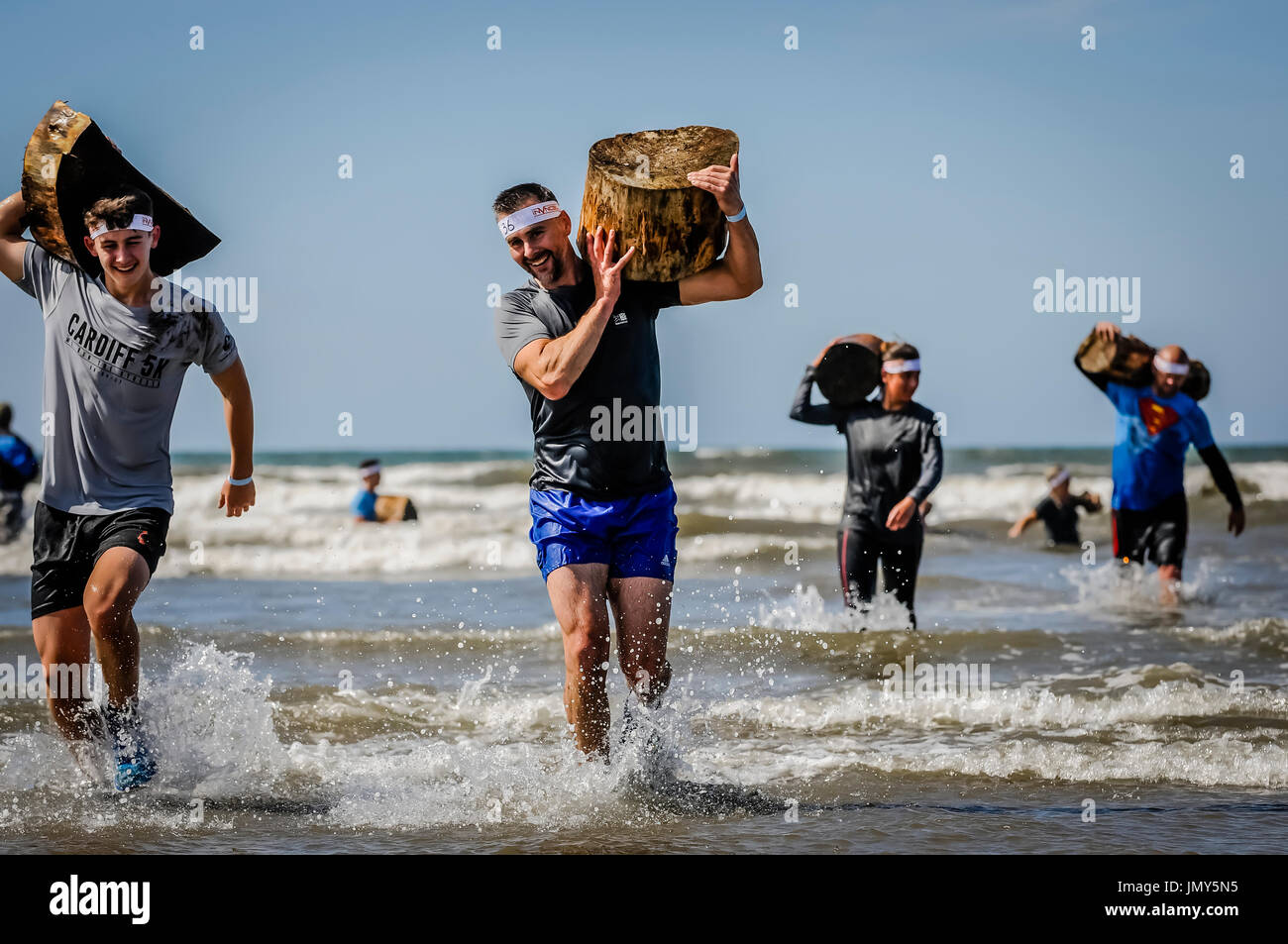 Log carry into the sea, unusual obstacle on obstacle course race Stock ...