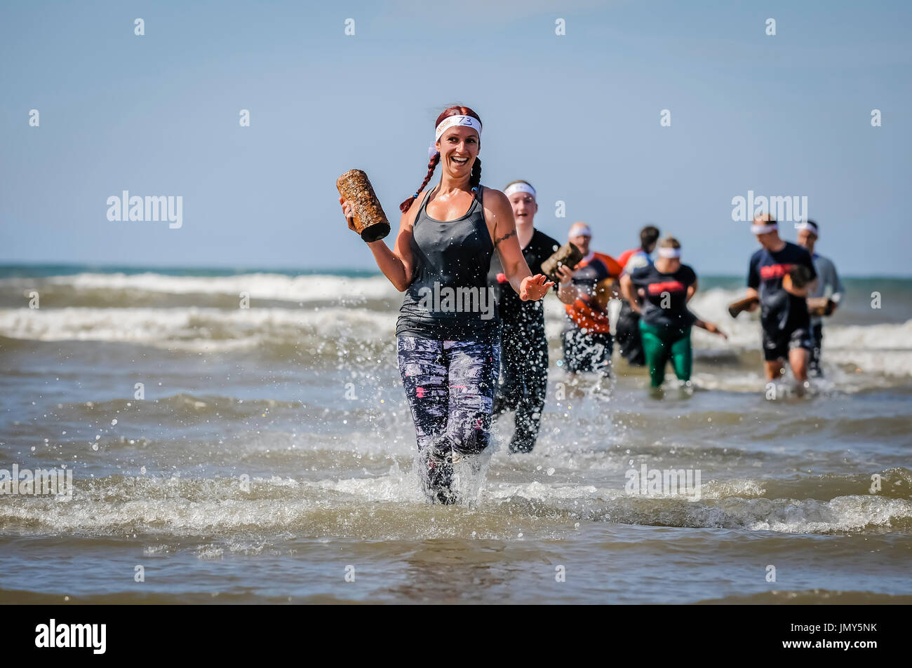 Log carry into the sea, unusual obstacle on obstacle course race Stock ...
