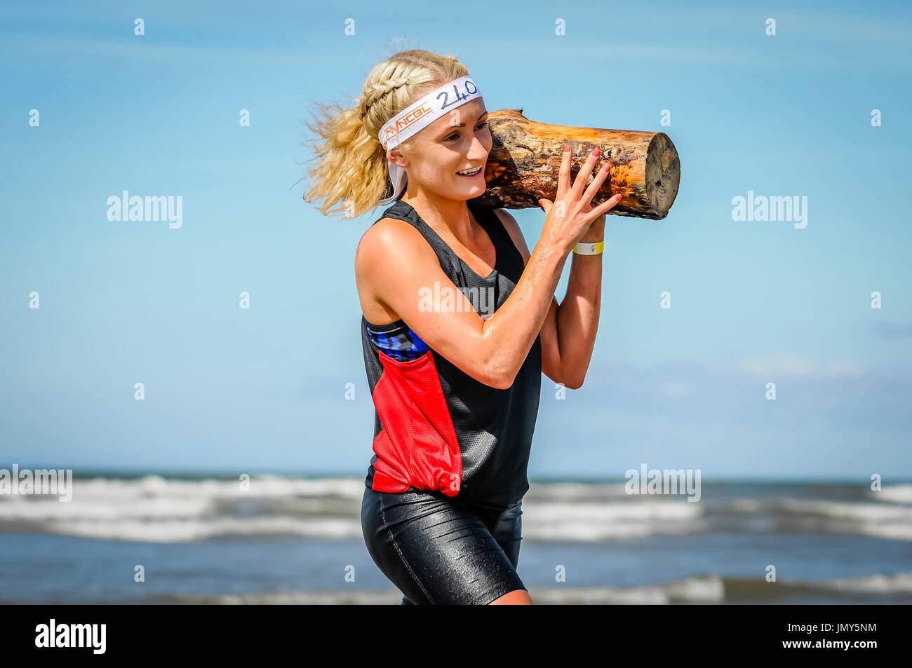 Log carry into the sea, unusual obstacle on obstacle course race Stock ...