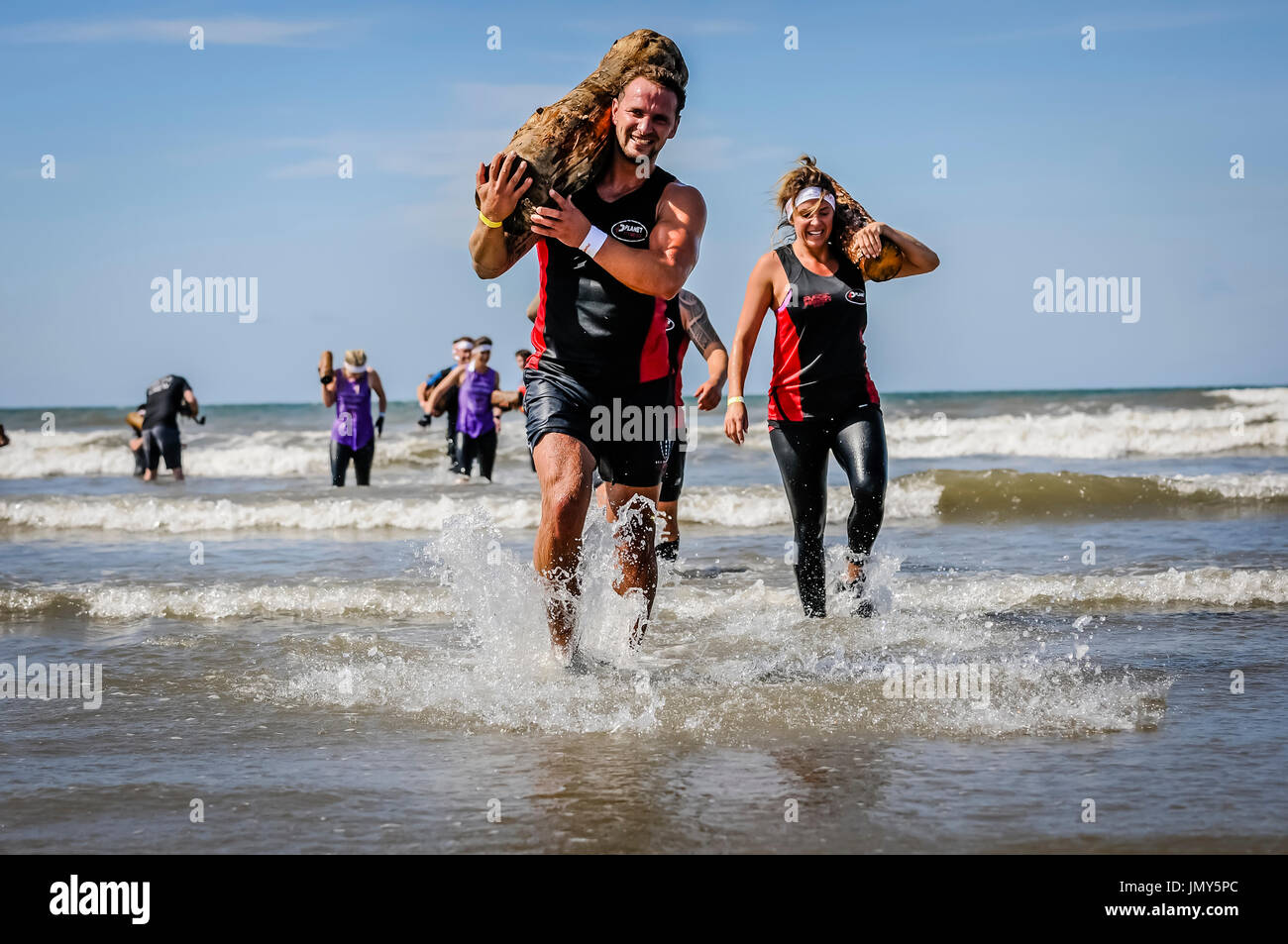 Log carry into the sea, unusual obstacle on obstacle course race Stock ...