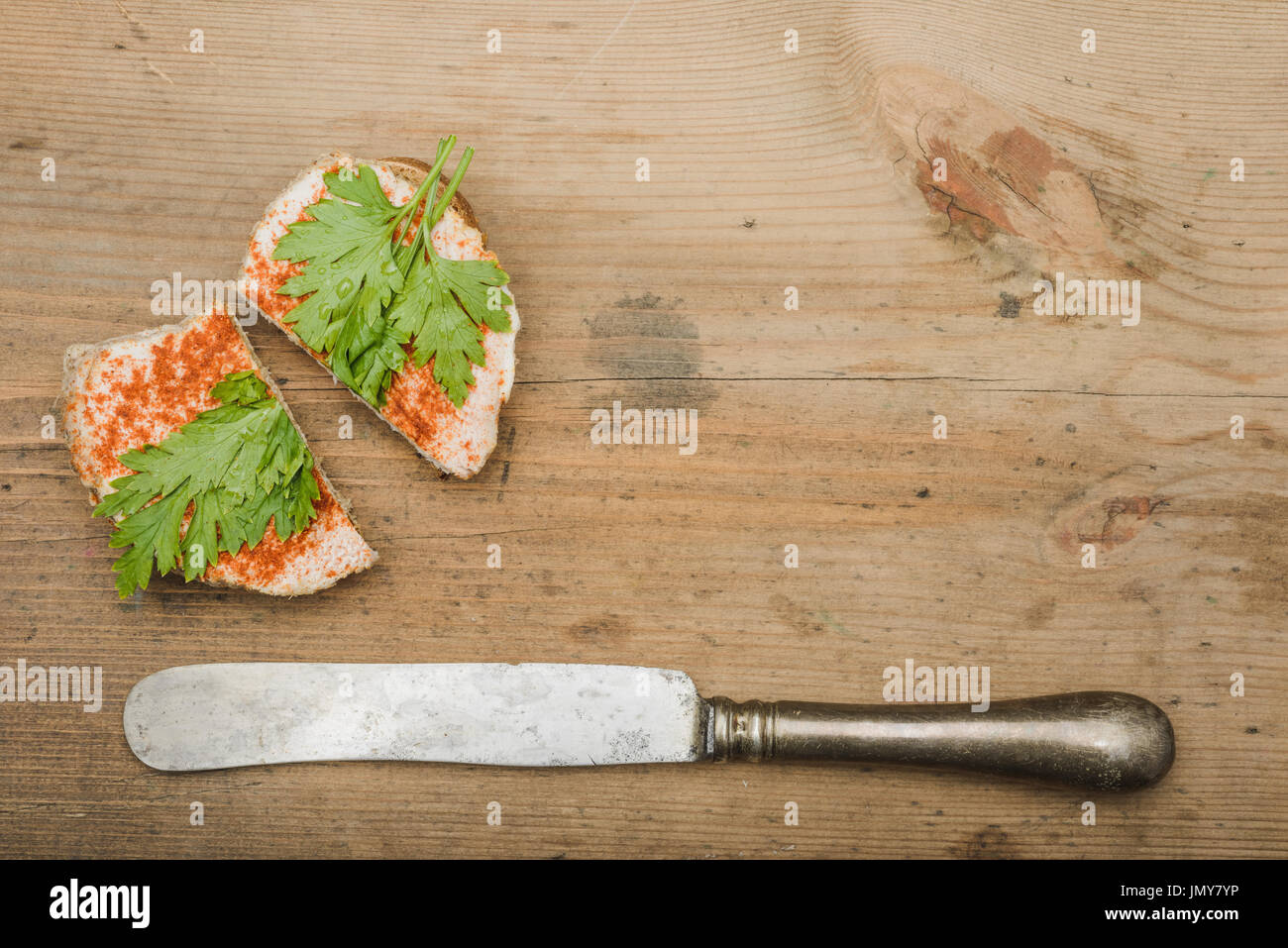 Sandwich wrapped in paper and tied with string on plywood abstract ...